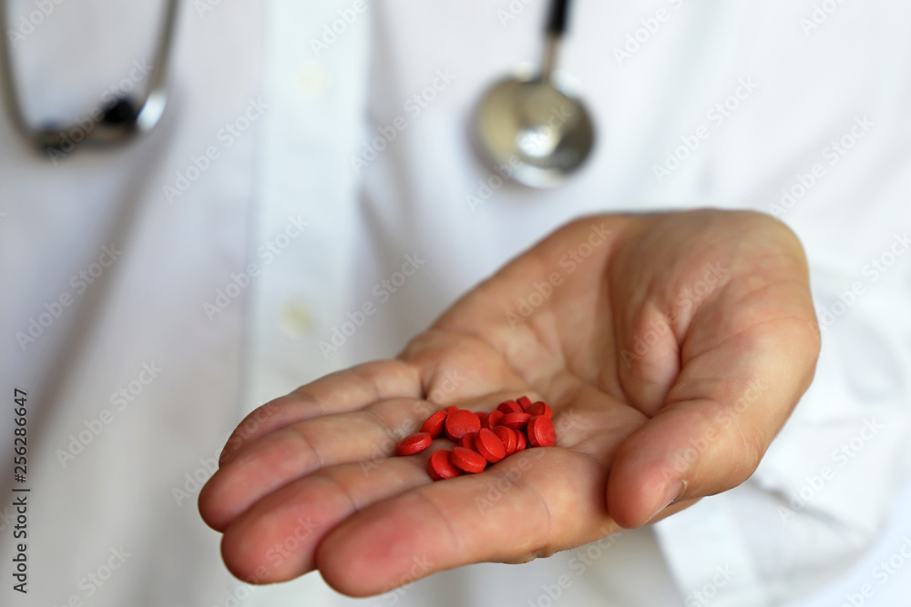 Therapist at the clinic, doctor with red pills, man with stethoscope ...