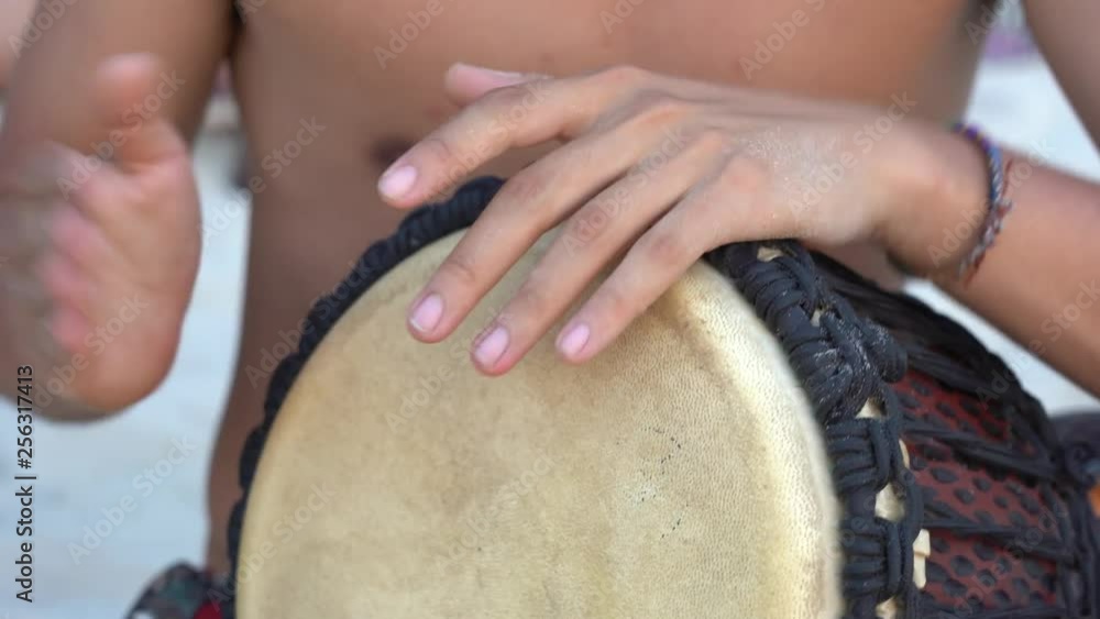 Man musician playing on a Bongo drum close up. Hand tapping a Bongo ...