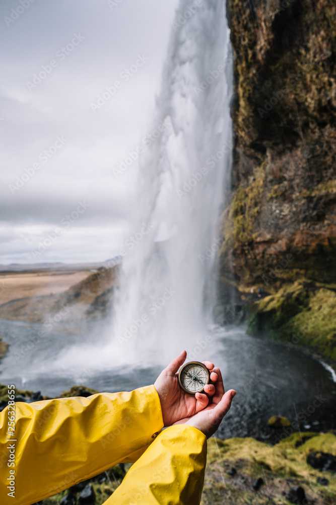 Iceland, Seljalandsfoss Waterfall, woman's hand holding compass Stock ...
