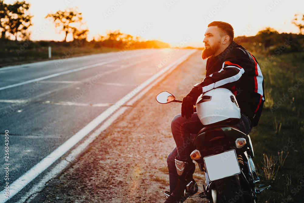 Side view portrait of a confident adult young caucasian male biker ...