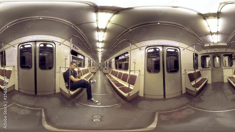 360 VR video. Inner view of moving subway train. Man commuter riding in ...