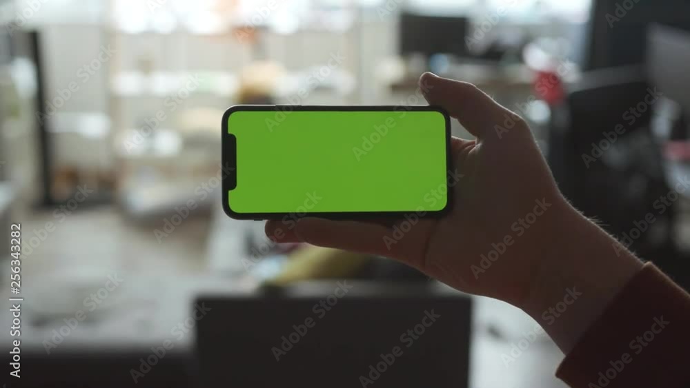 Close up view of man’s hand holding horizontally green screen ...