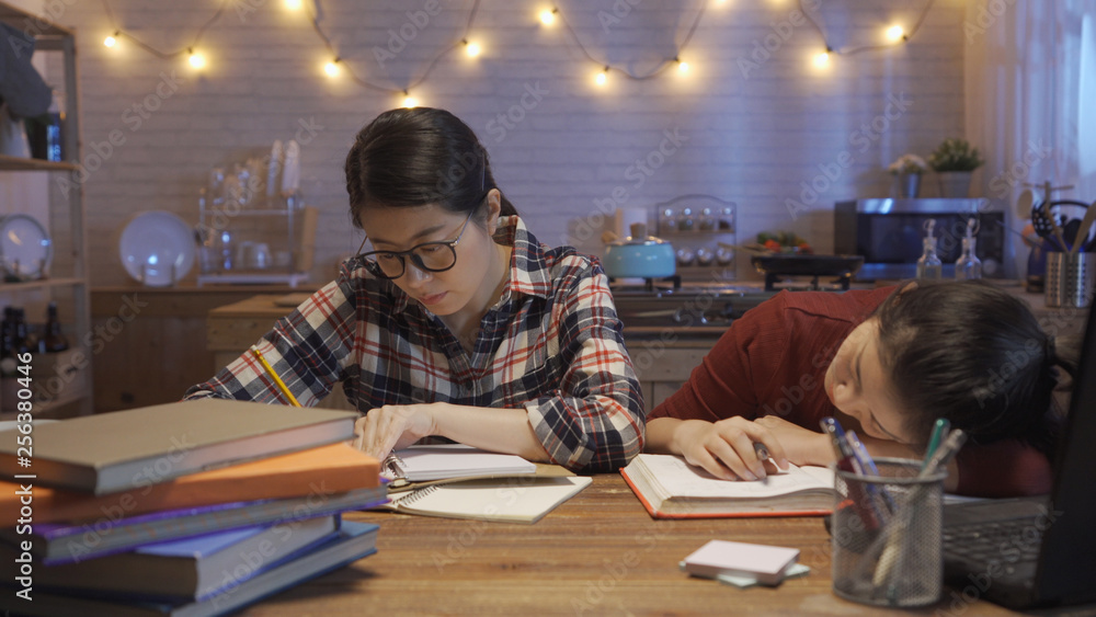 front view of tired student studying with laptop computer at home in ...