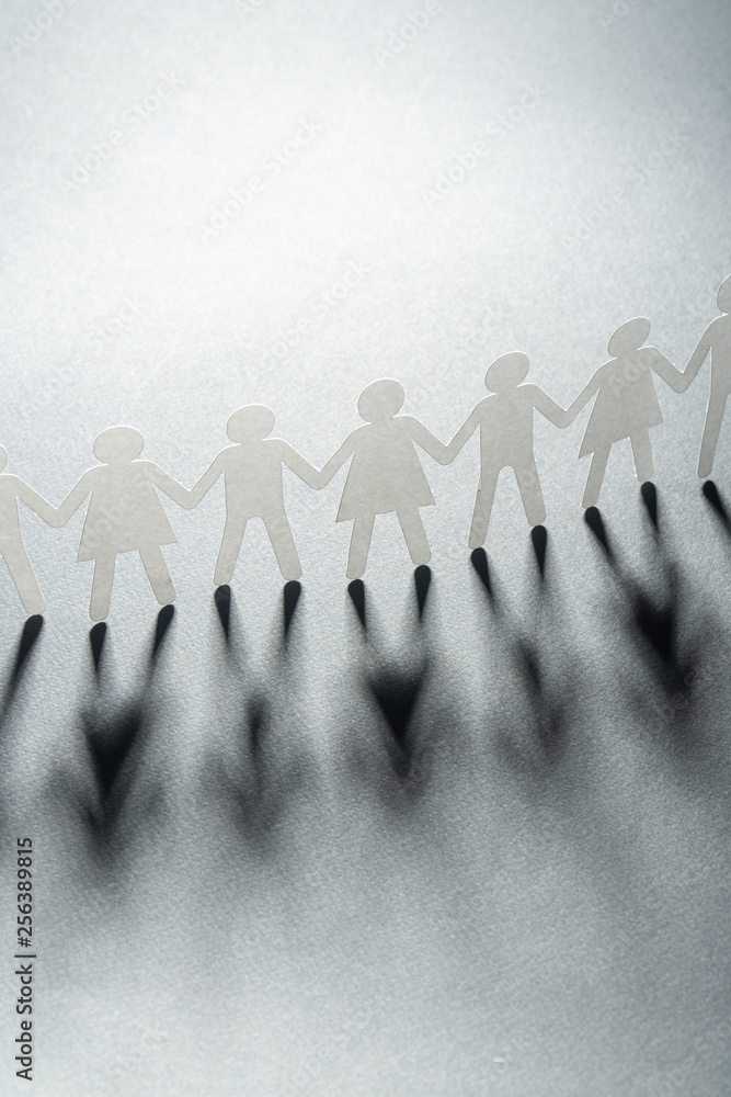 Chain of paper people rallying as in protest or demonstration, concept ...