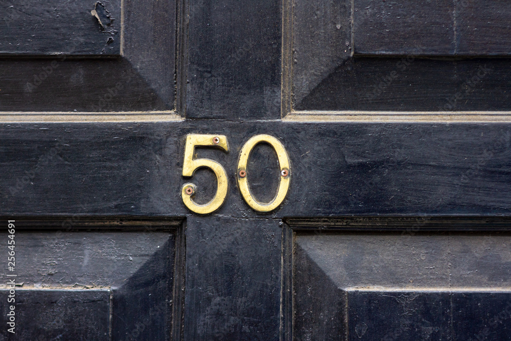 House number 50 with the fifty in bronze numbers screwed to a black ...
