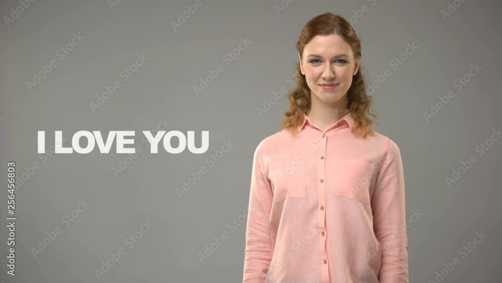 Deaf woman saying love you in sign language, text on background ...