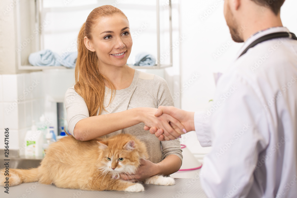 Handsome male vet talking to his female client Stock Photo | Adobe Stock