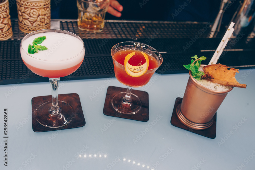 bartender hand holding Three cocktails Sweet Famous juicy Pinkwhite ...