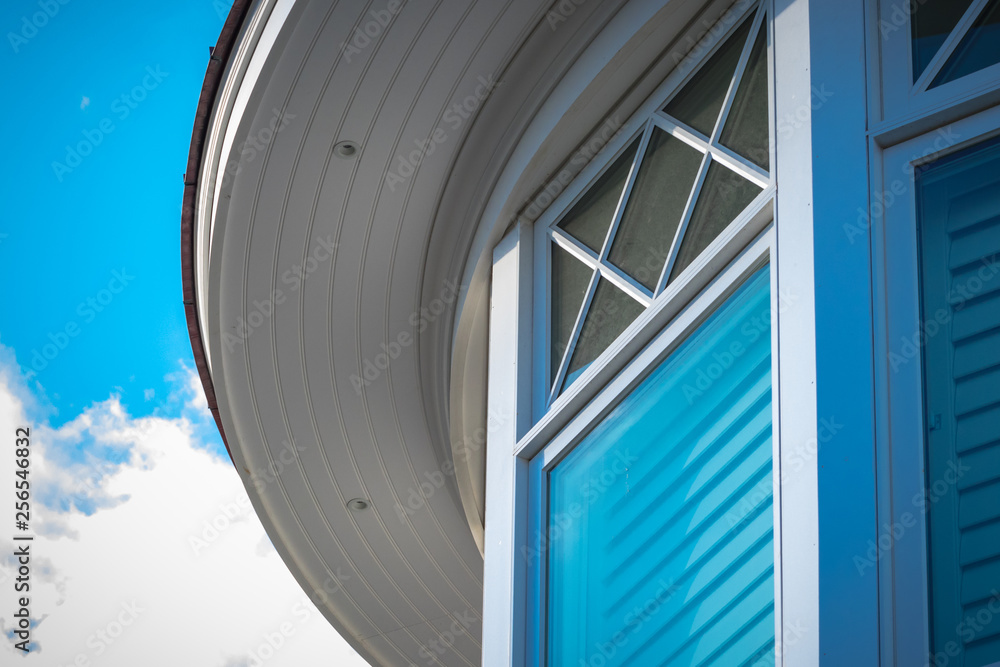 Sun shines on window and curved awning of luxury beach house. Stock ...