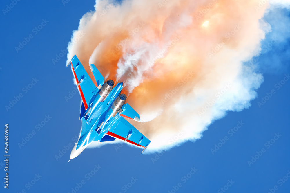 modern military fighter jet airplane flying surrounded by fire and ...