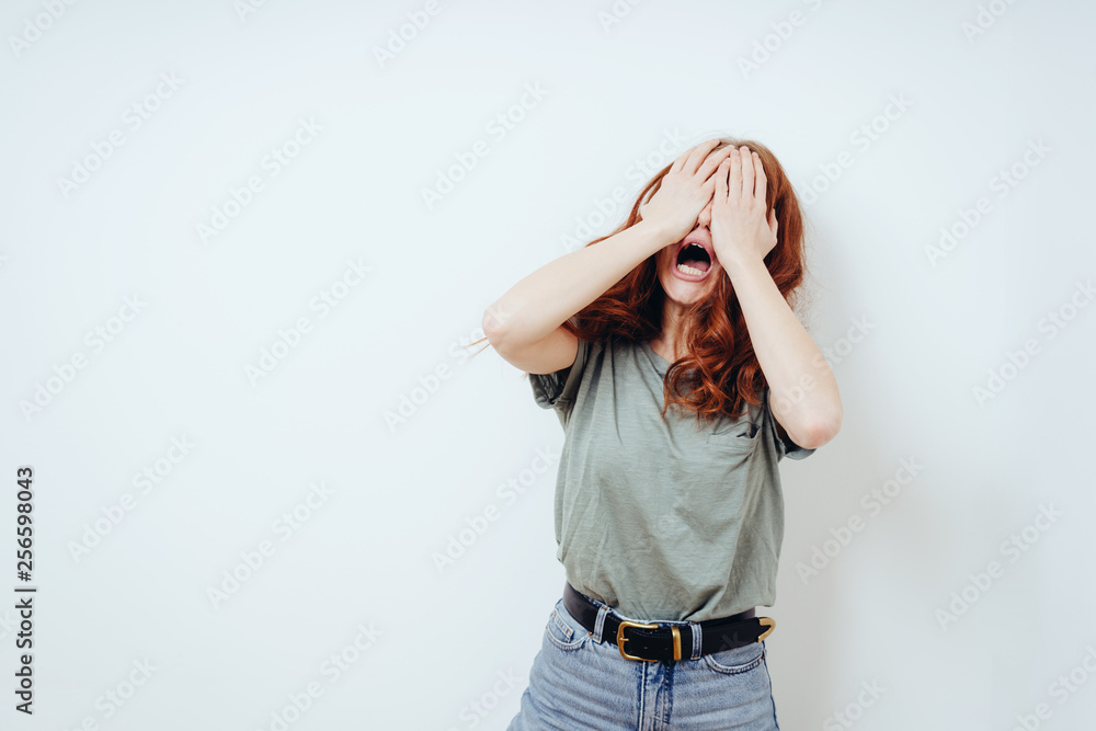 Anguished young woman covering her eyes Stock Photo | Adobe Stock