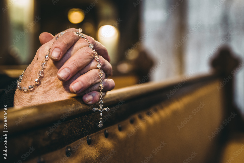 Praying hands with rosary in church Stock Photo | Adobe Stock