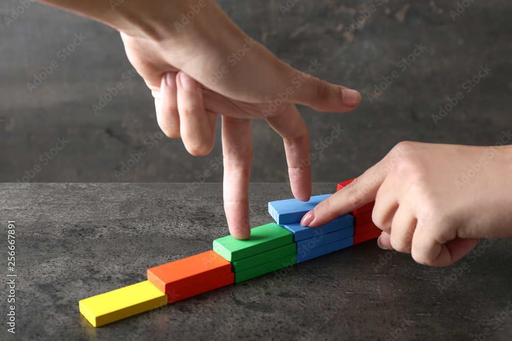 Human hand imitating walking upstairs and another hand obstructing its ...