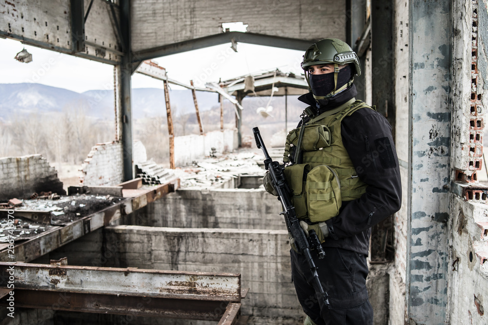 Special forces modern soldier standing in ruined building after the ...
