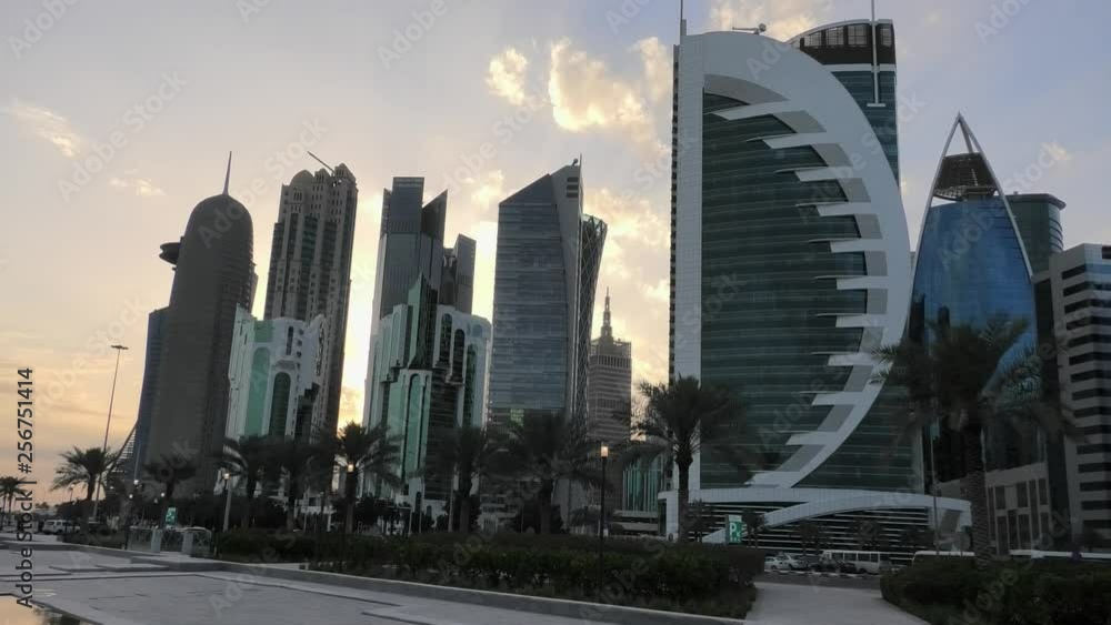 Doha West Bay high rises at blue hour reflecting in the water of park ...