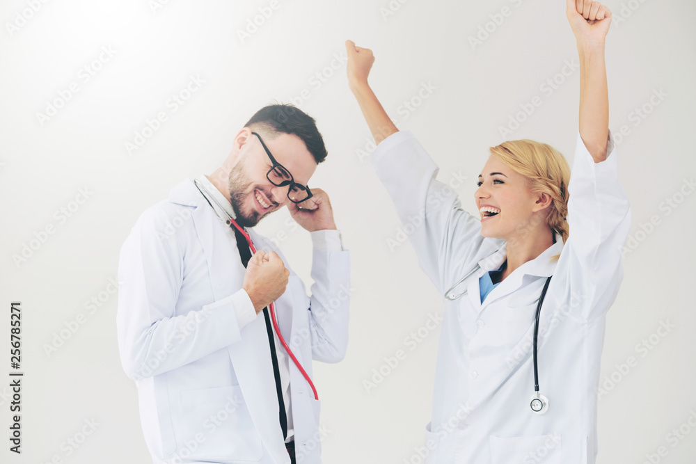 Happy successful doctor celebrates victory in hospital office with ...