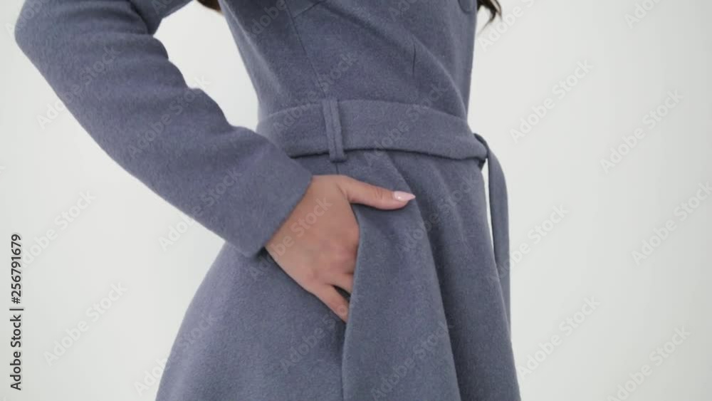 the girl touched his gray coat close-up, a woman's hand touched the ...