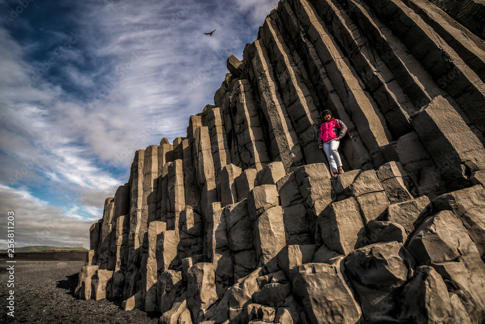 Traveler travel to unique volcanic rock formation on Iceland black sand ...