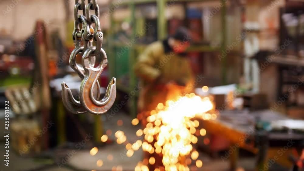 Construction plant. A big industrial lifting chain with a hook on the ...