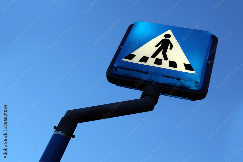 Traffic sign for pedestrian crossing. Real, blue sky. Stock Photo ...