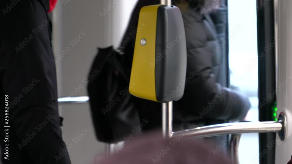 People in the tram standing at the door and waiting for the exit. After ...