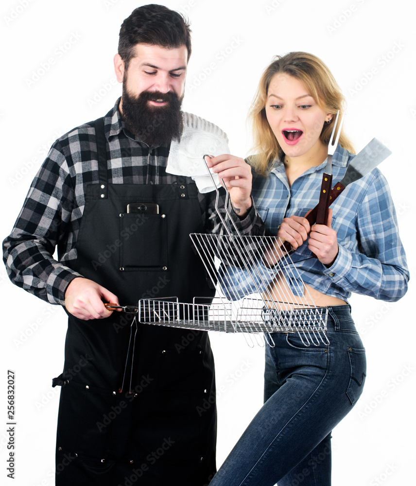 Better grilling is grilling together. Couple of cooks using barbecue ...