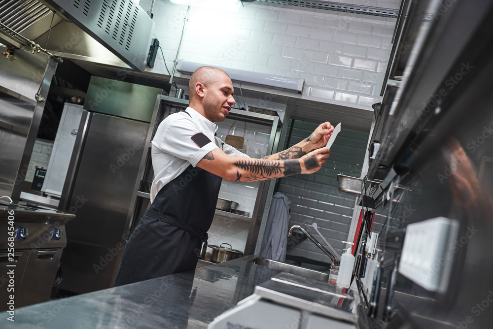 What is next... Handsome bald male chef with tattoos on his arms ...