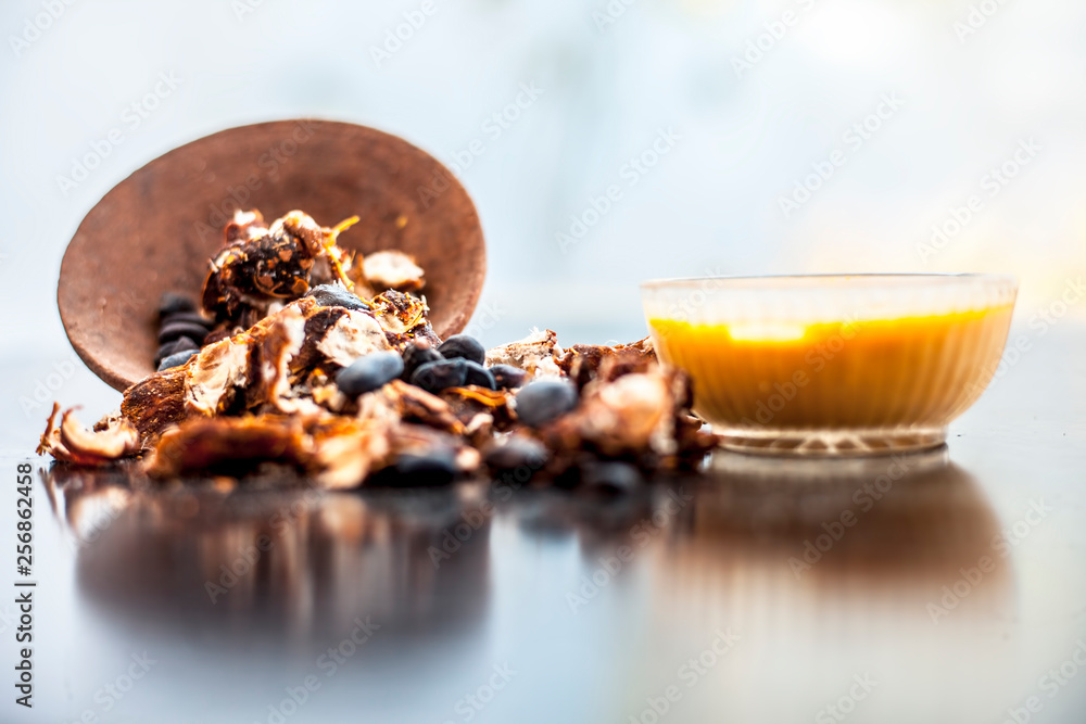Tamarind or imli or amli in a clay bowl along with its roasted seeds ...