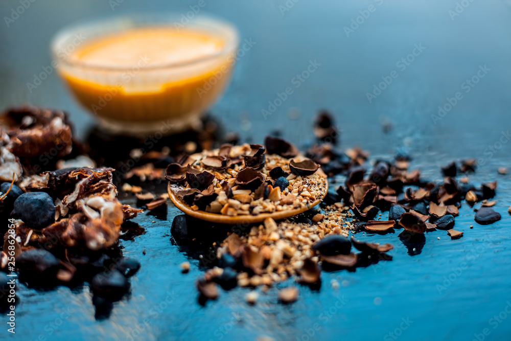 Tamarind or imli or amli in a clay bowl along with its roasted seeds ...