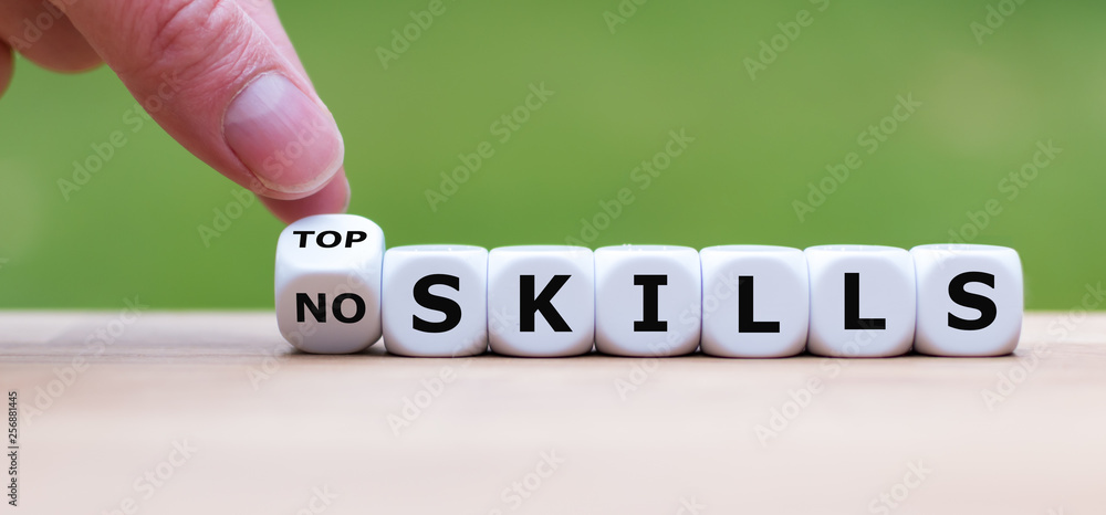 Hand turns a dice and changes the expression "no skills" to "top skills ...