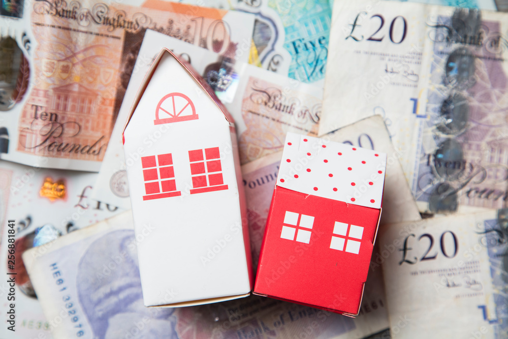 Housing cost. Paper toy house with British currency notes Stock Photo ...