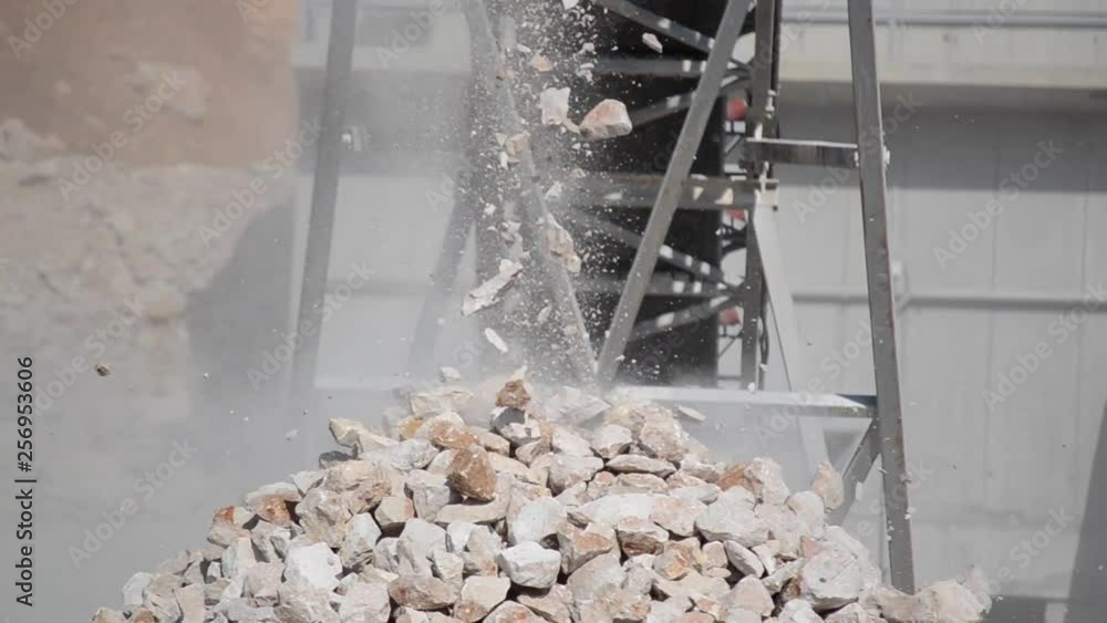 Quarrying of limestone in a quarry. Crushed stones pouring from ...
