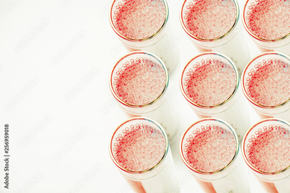 Top view and closeup lots of medical capillary glass tube in container ...