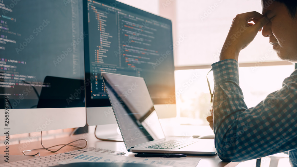 Male Programmers Are Stressed At The Office While Working Analyzing On