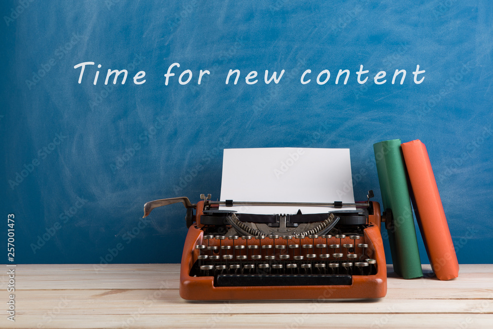 writer's workplace - red typewriter and stationery on blue blackboard ...