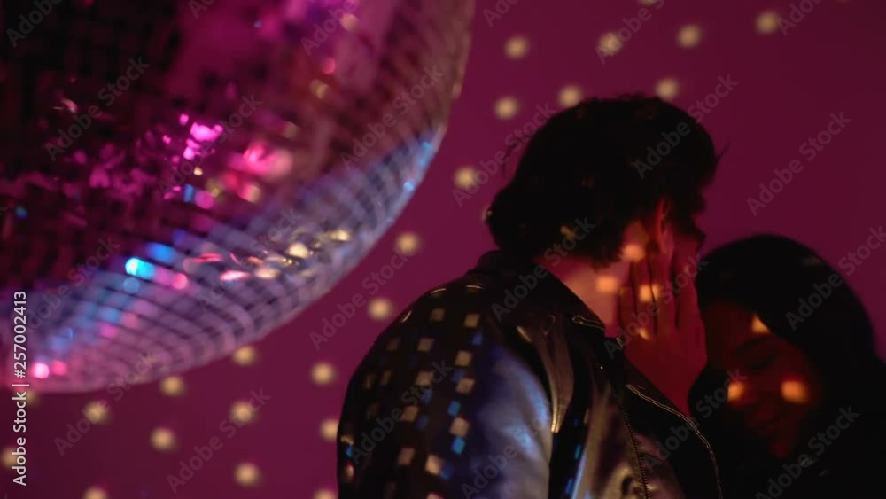 Playful drunk couple making out at party in night club, passionate kiss ...