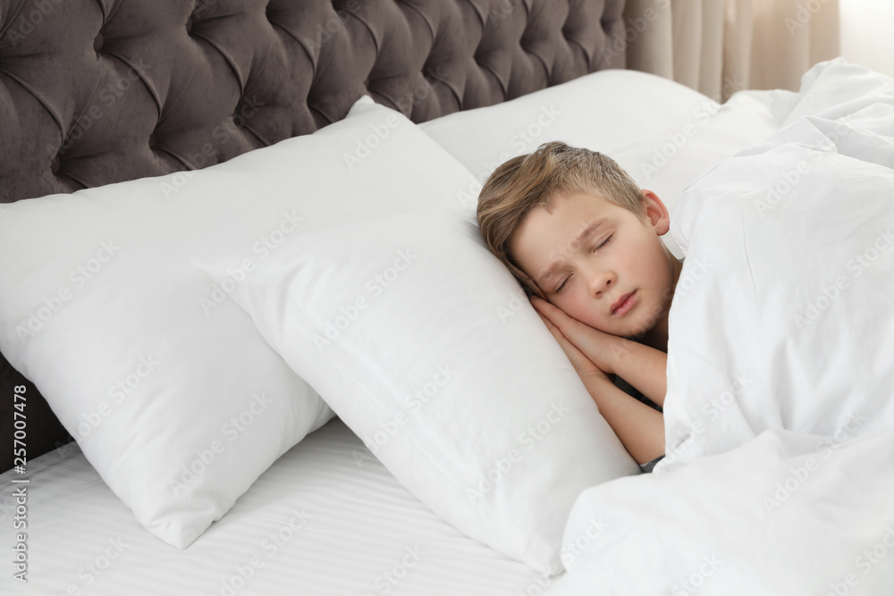 Cute tired boy sleeping in comfortable bed Stock Photo | Adobe Stock