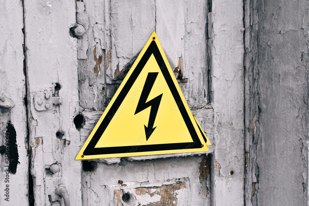 Caution, high voltage! Triangular sign of danger and high electricity ...