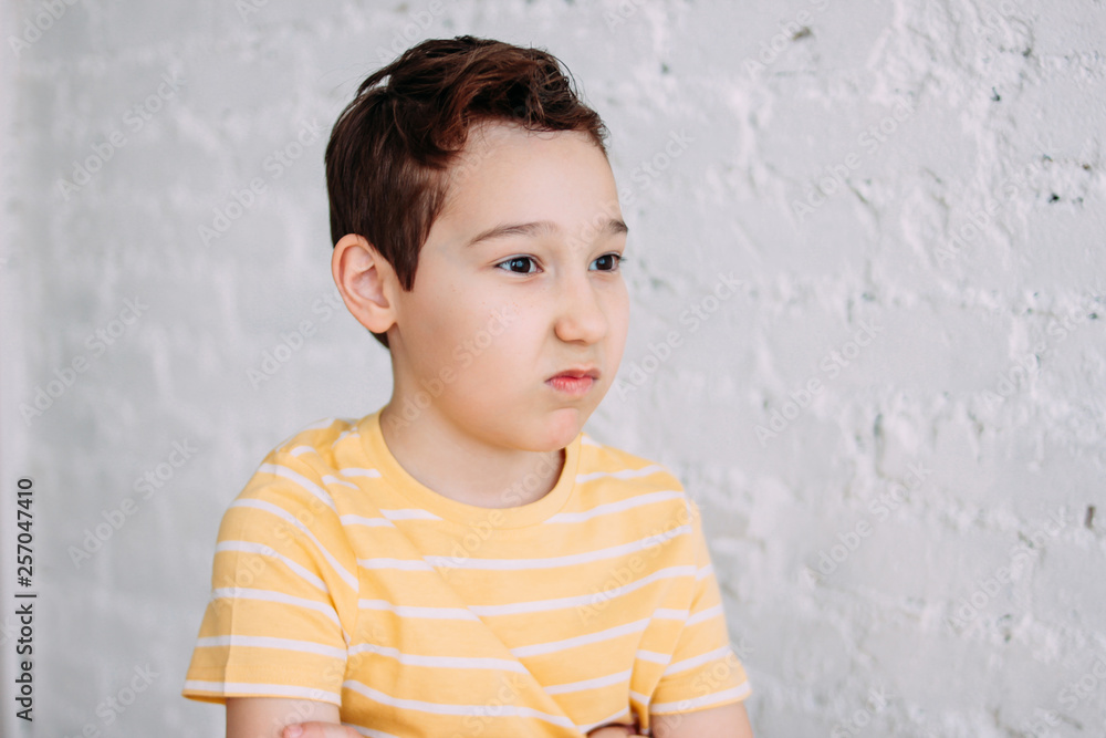 Cute tween angry boy with funny face in yellow t-shirt isolated on ...