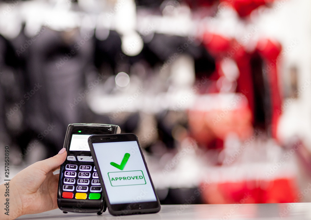 POS terminal, Payment Machine with mobile phone on store background ...