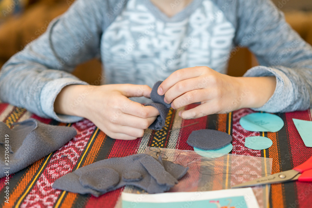Foto de Little girl with a needle and thread. creation. little girl ...