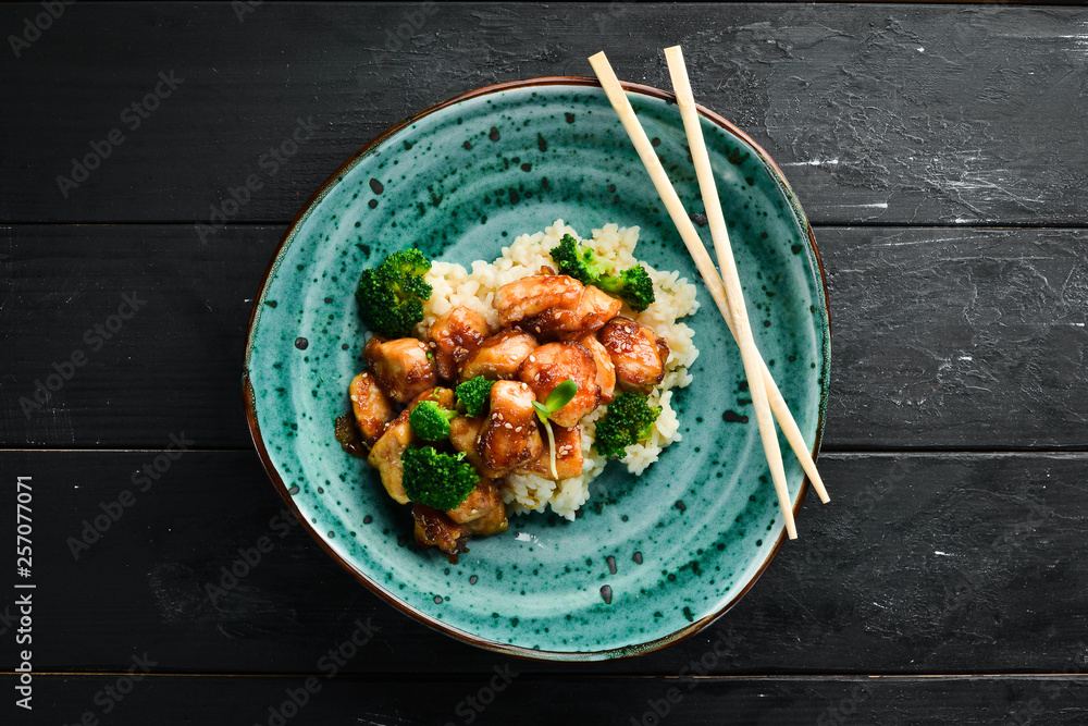 Rice with chicken fillet and broccoli. Thai cuisine. In the plate. Top ...