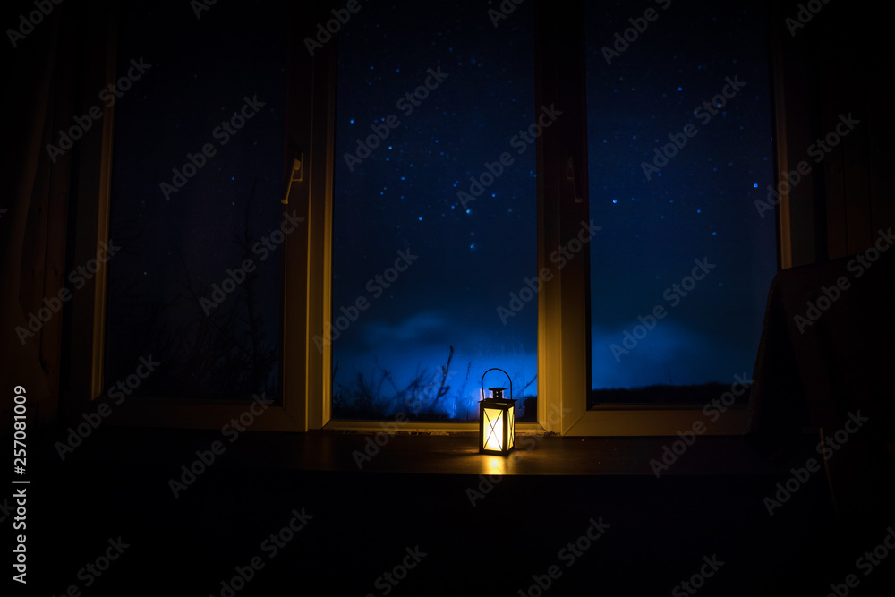 Night scene of stars seen through the window from dark room. Night sky ...