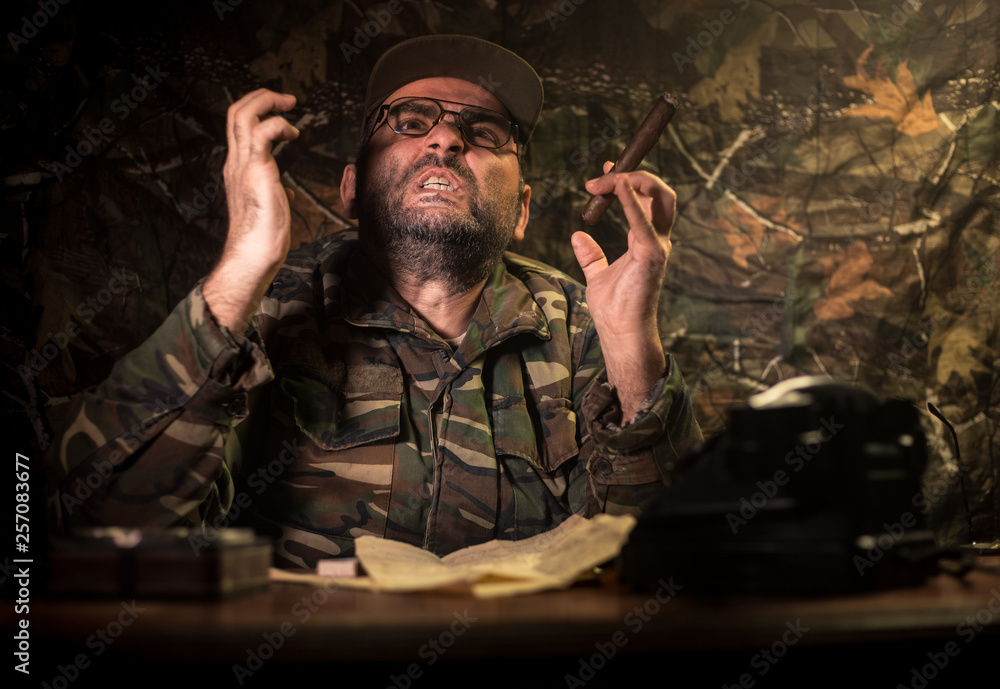 Foto de The evil dictator sitting on table. Angry communist general ...
