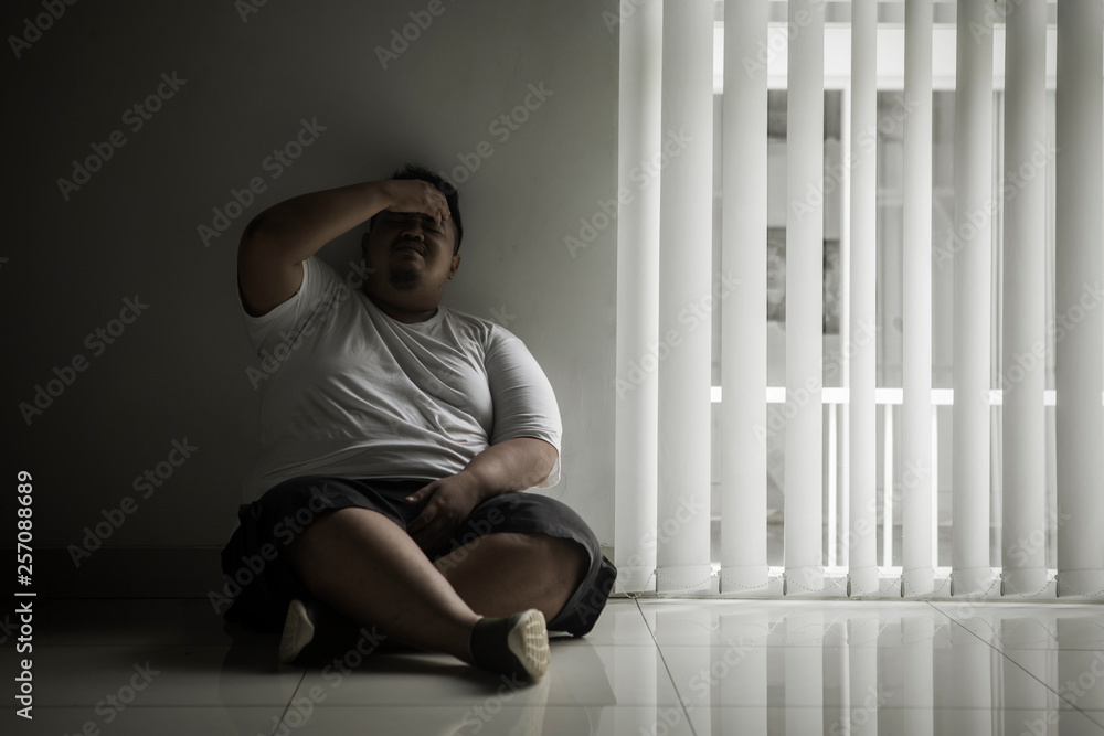 Lonely fat man crying near the window Stock Photo | Adobe Stock