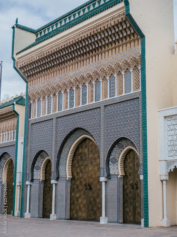 huge golden gate of the Royal Palace of Fez on a beautiful afternoon ...