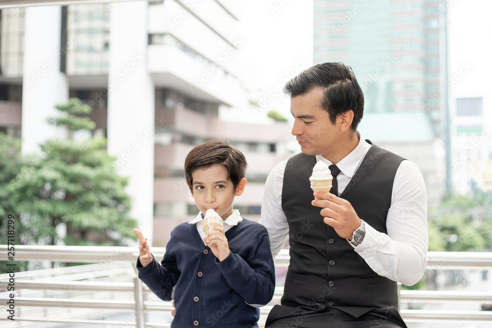 Father single dad and son fill happy eating ice cream cones together on ...