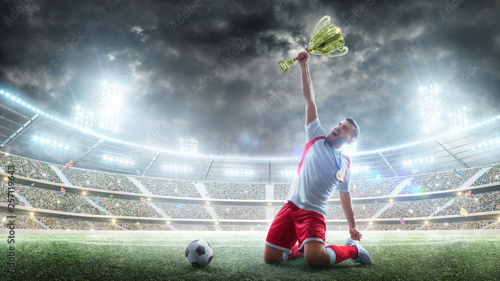 Soccer player celebrates winning the open stadium. Soccer player holds ...