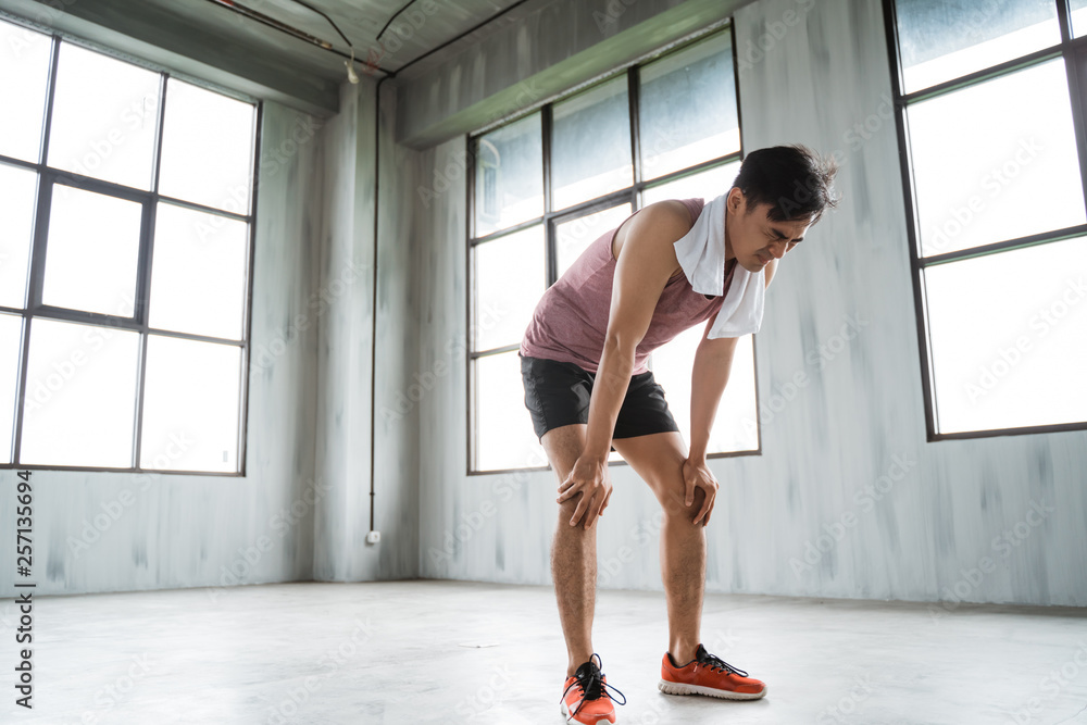 tired asian sport man take a break after high intensity workout in the ...