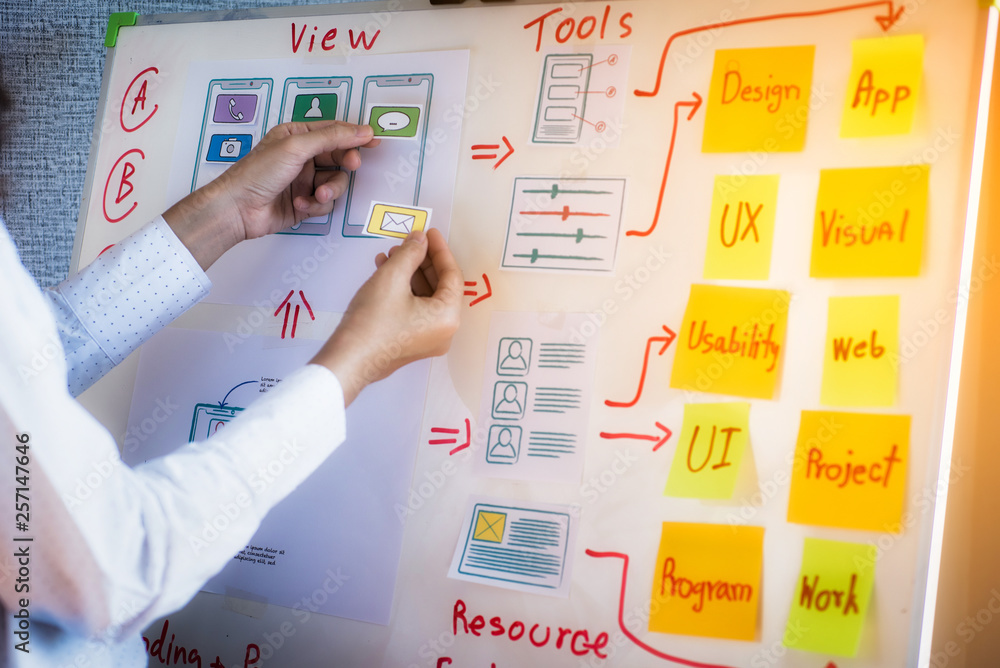Young creative graphic planning with sketch drawing for application ...